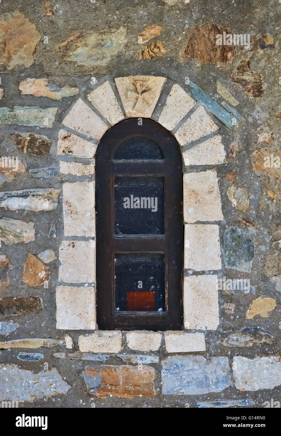Mediterranean architecture detail with an old window and stone wall ...