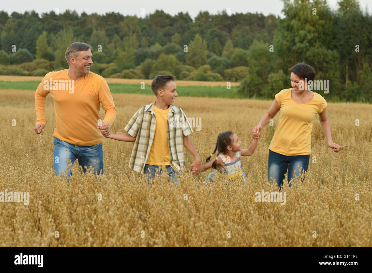 happy family at field Stock Photo - Alamy