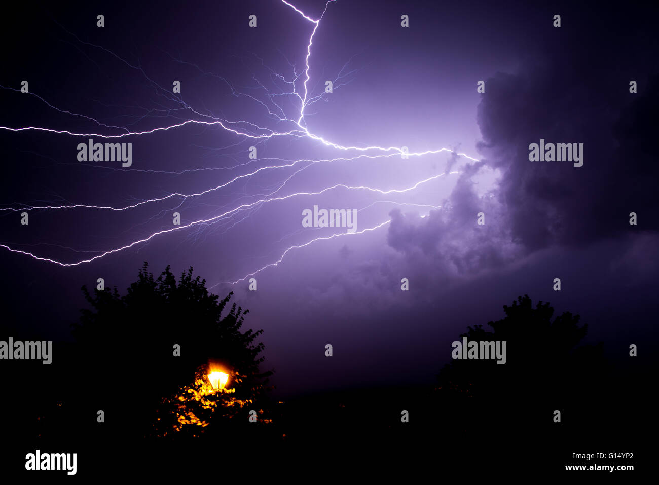 Lightning strikes over street light Stock Photo - Alamy