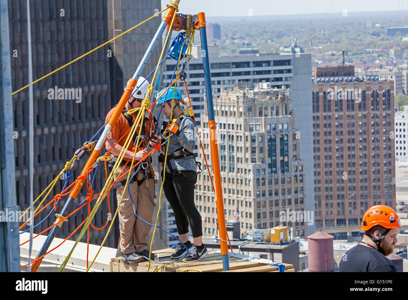 Detroit, Michigan - People rappel down a 25-story building as a ...
