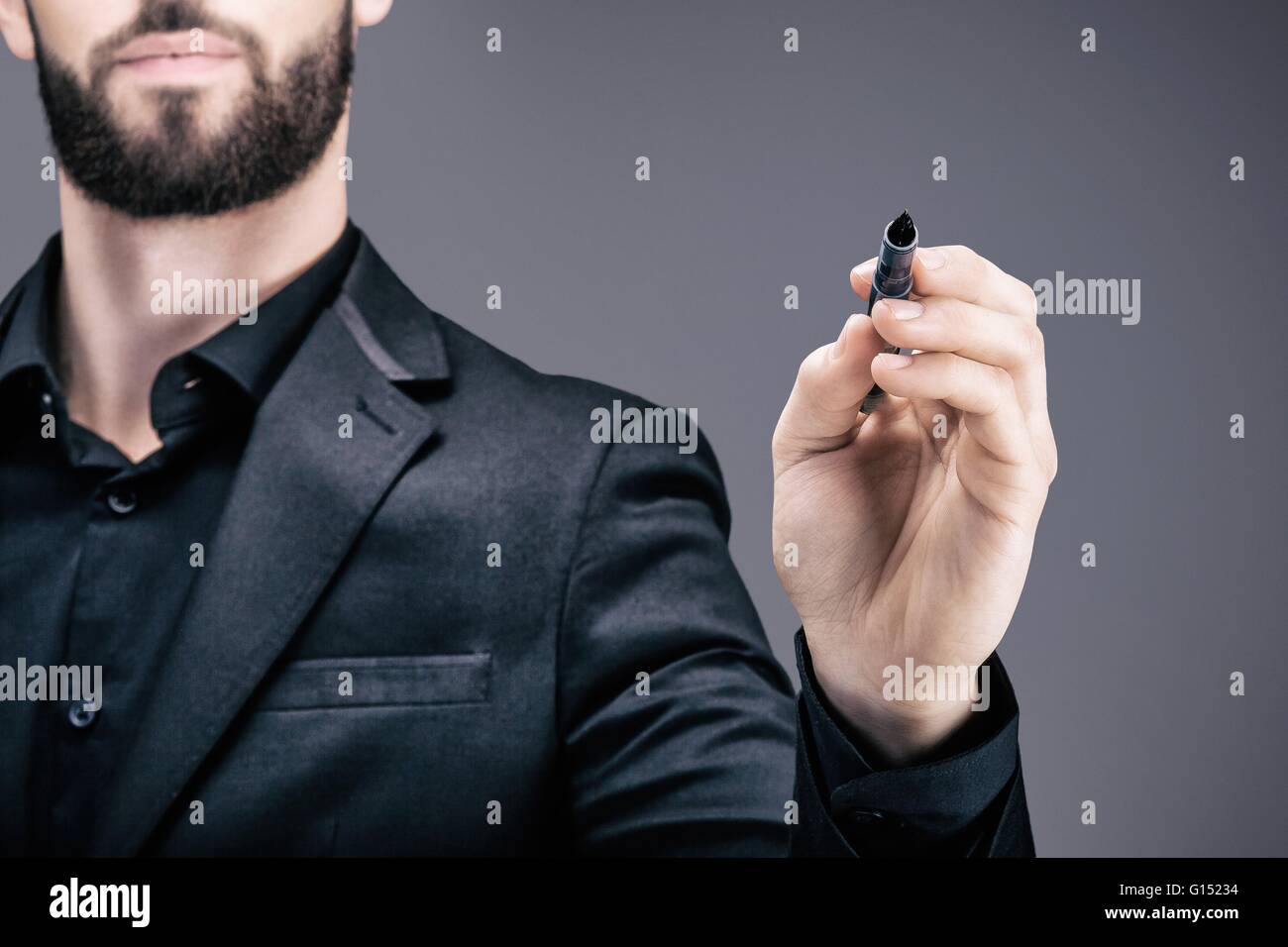 Black hand holding a pen hi-res stock photography and images - Alamy