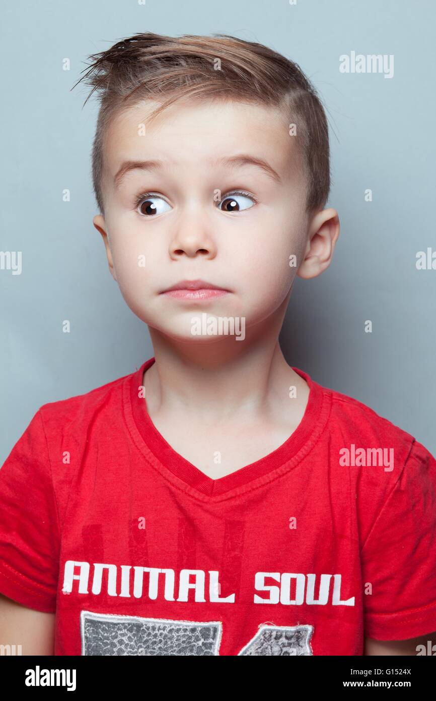 Portrait of a surprised boy, looking to the side Stock Photo - Alamy