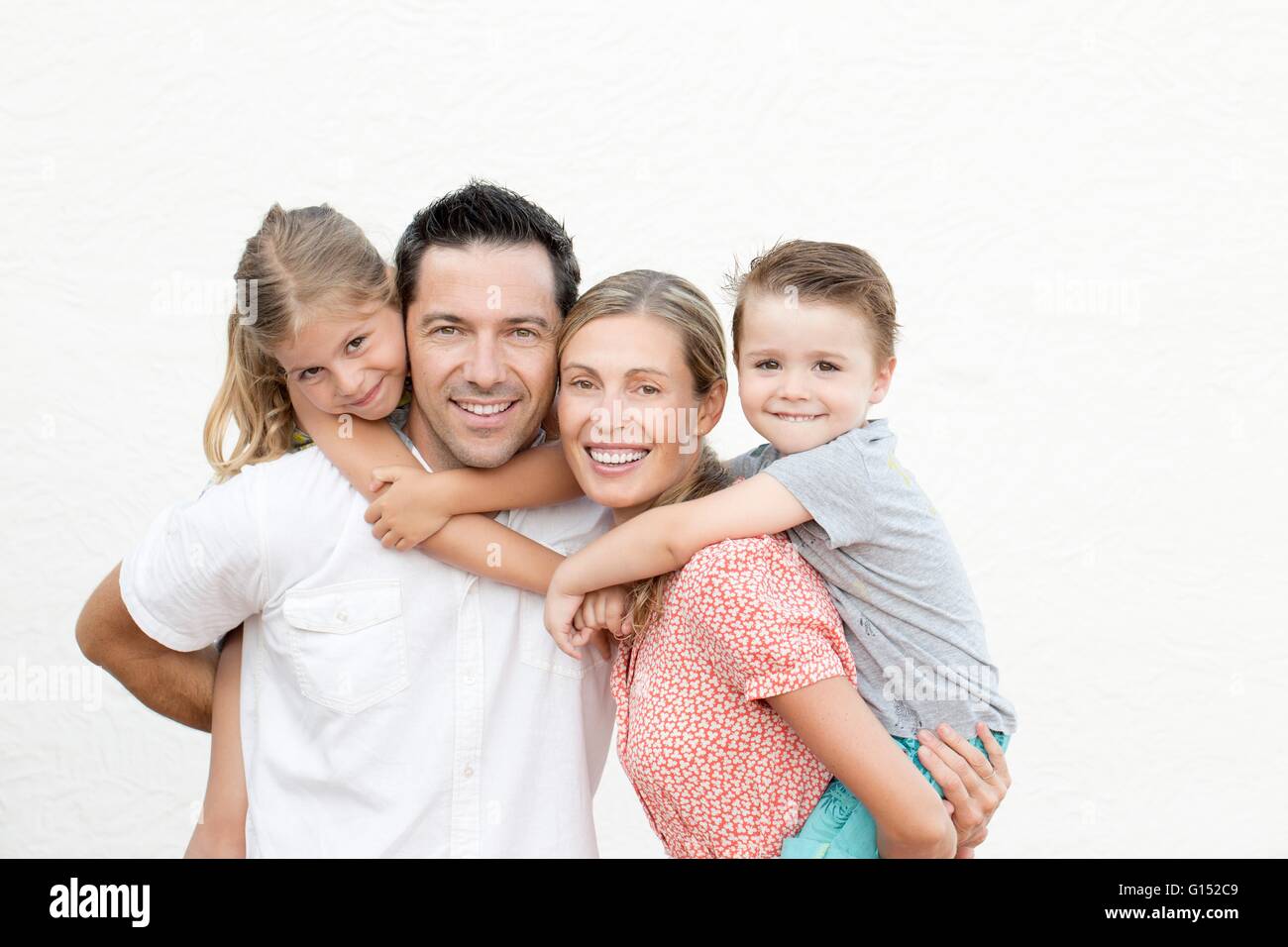 Family portrait, parents with their children on their back Stock Photo ...