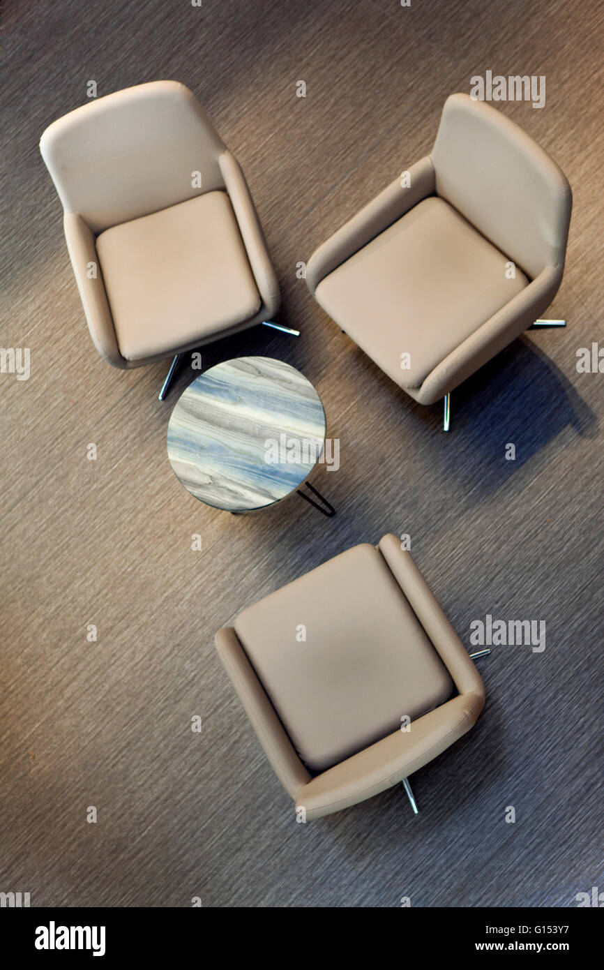 Seats and small table in a room Stock Photo - Alamy