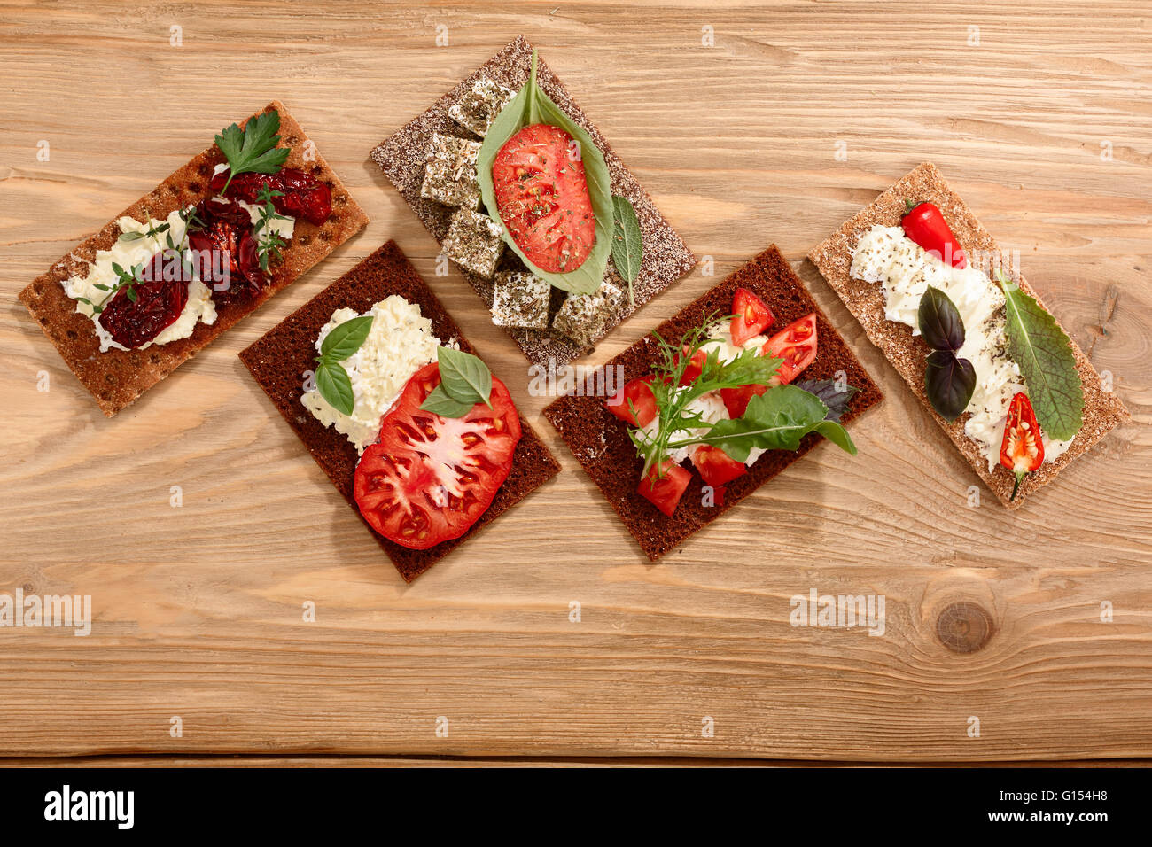 Different bread crisps (crispbread open-faced sandwiches) with both ...