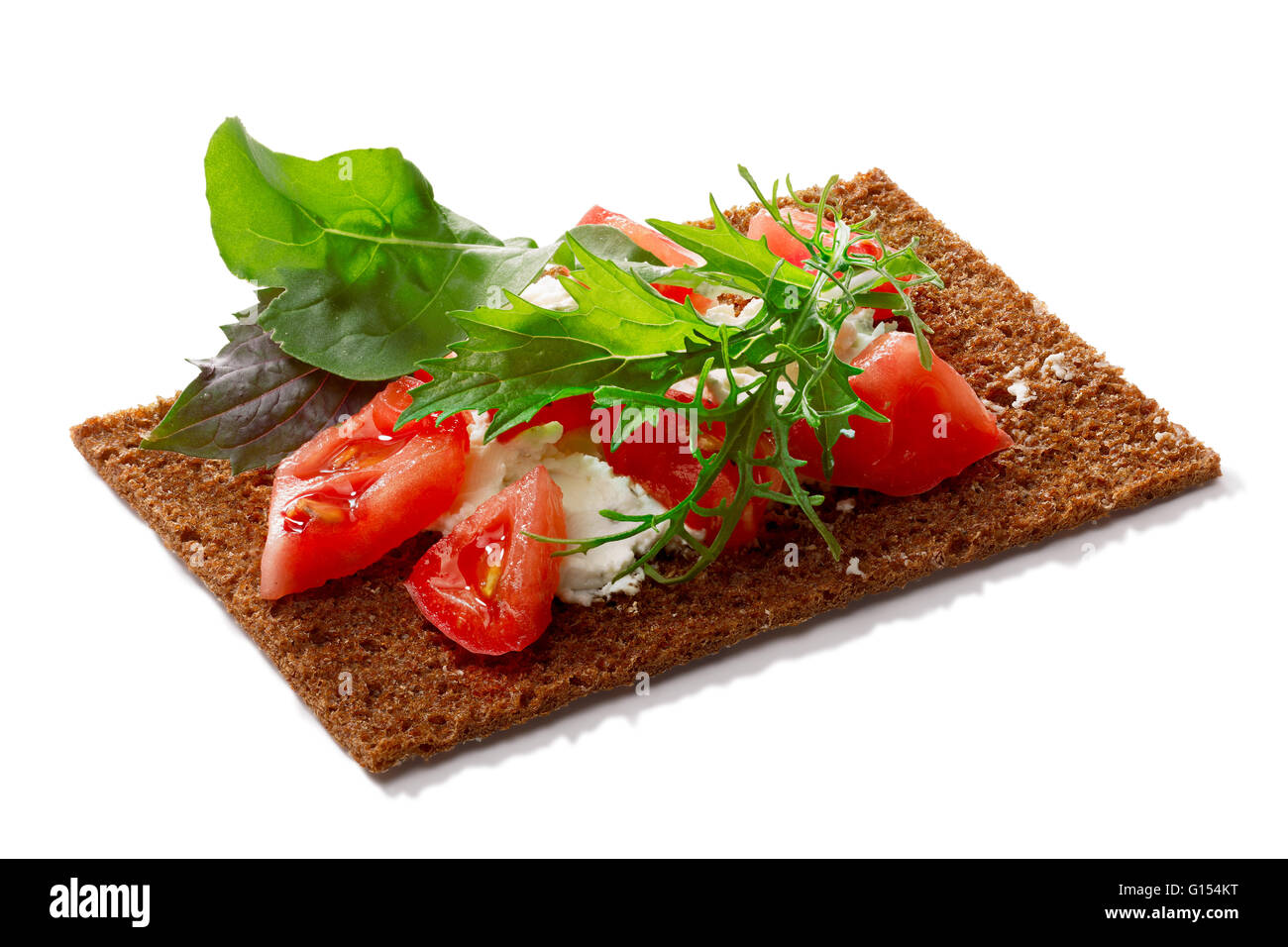 Bread crisp (crispbread open-faced sandwich) with heirloom tomato, soft ...