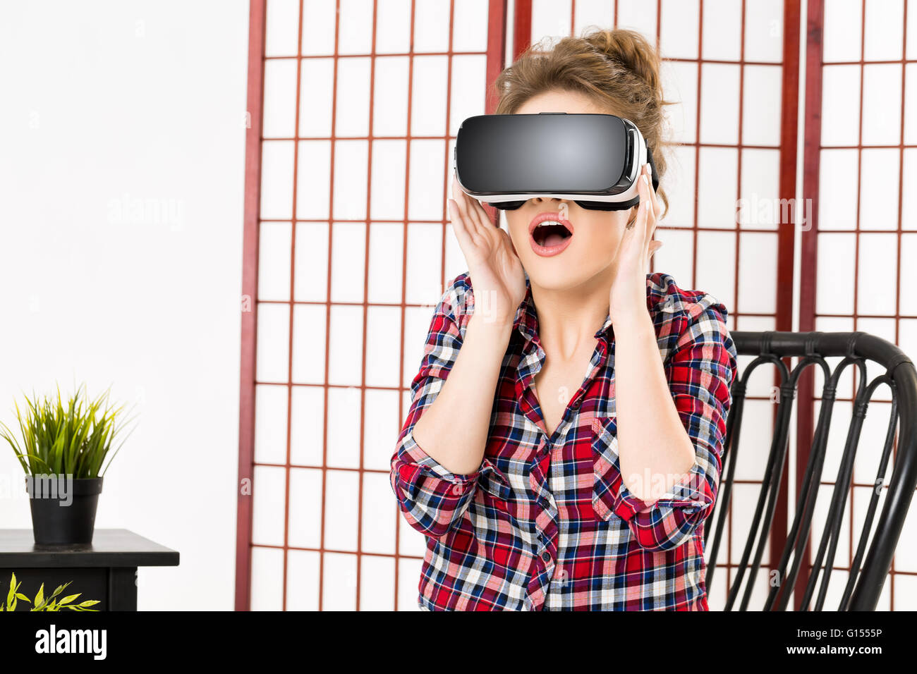 Girl getting experience using VR-headset glasses of virtual reality ...