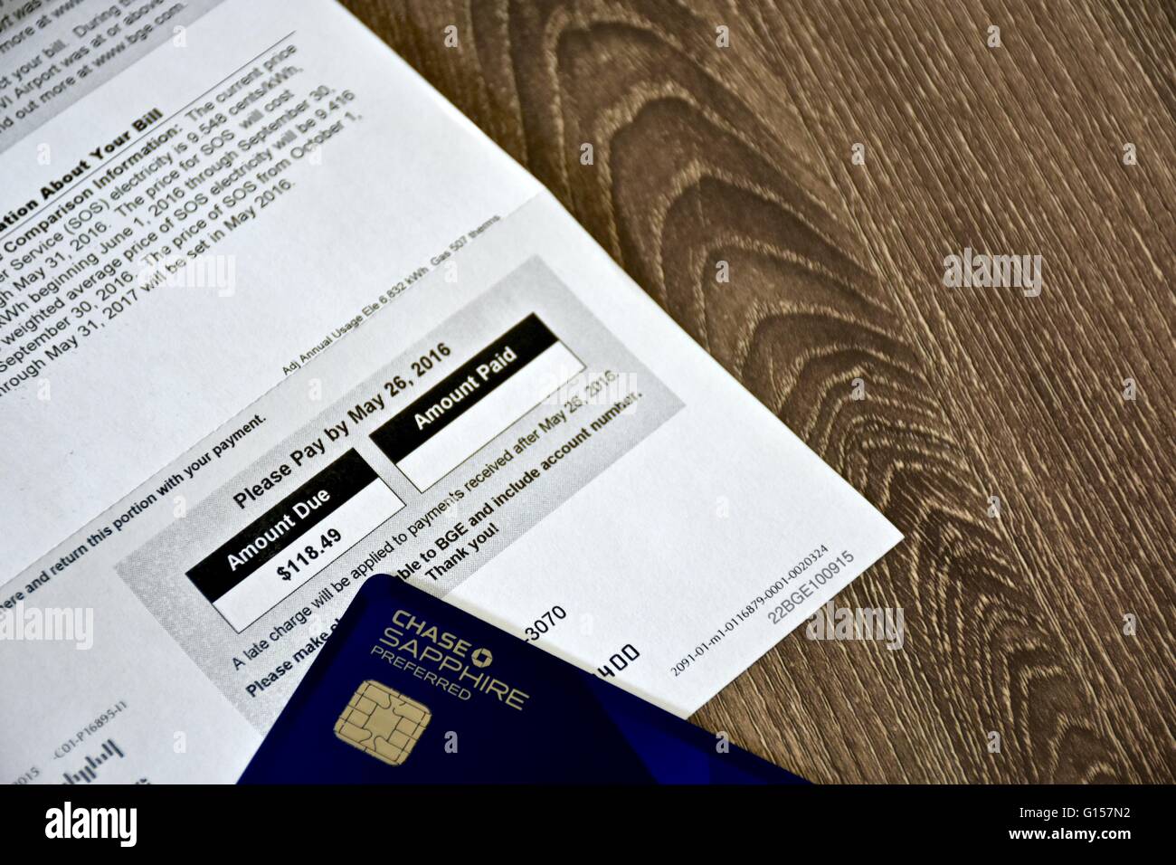 Utility bill laying on a wood surface next to the Chase Sapphire ...