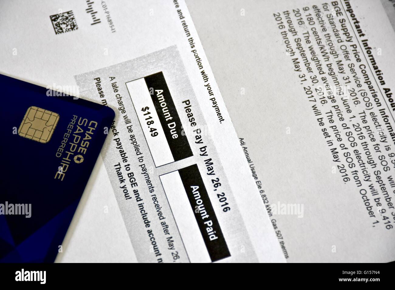 Utility bill laying on a wood surface next to the Chase Sapphire ...