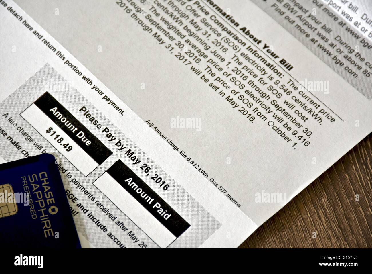 Utility bill laying on a wood surface next to the Chase Sapphire ...