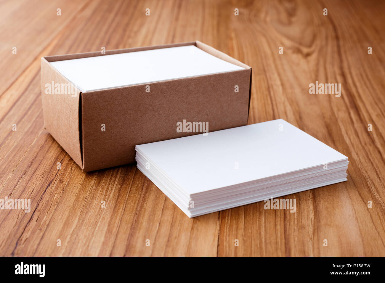 Business card stack blank mockup with kraft box on wood desk Stock ...