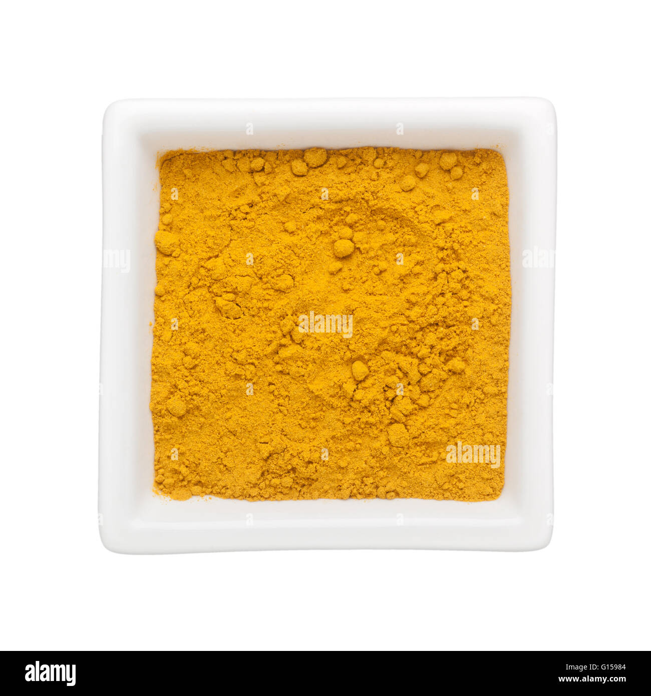Turmeric powder in a square bowl isolated on white background Stock ...