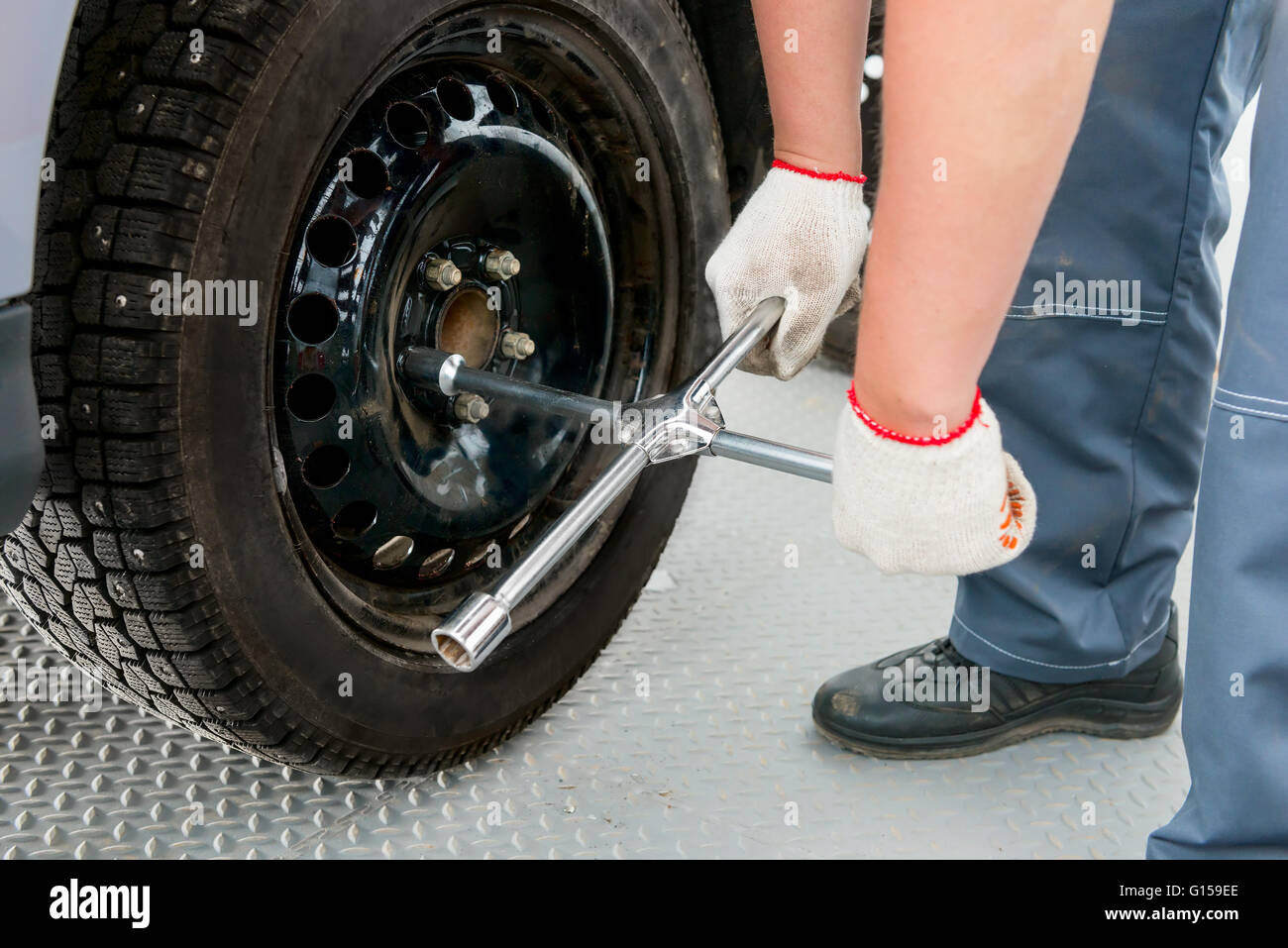 the process of replacing the wheel in the garage Stock Photo - Alamy