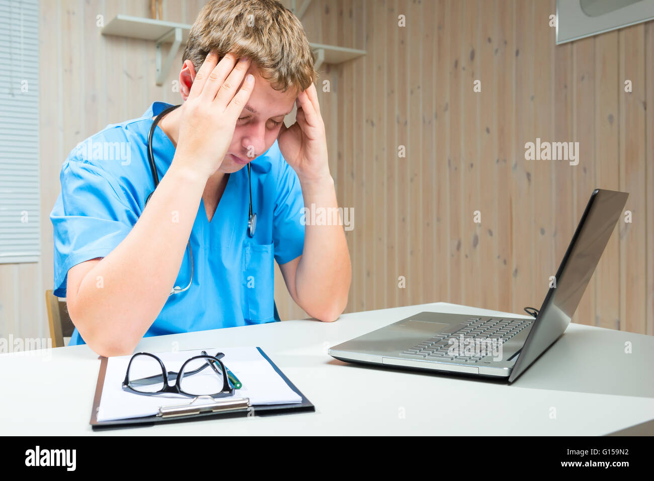 Tired doctor at computer hi-res stock photography and images - Alamy