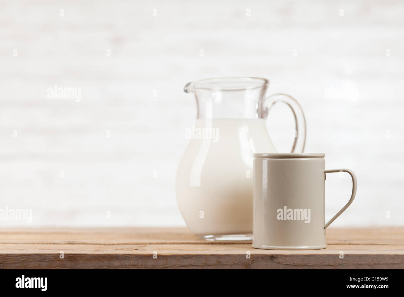 Milk jar on wooden table Stock Photo - Alamy