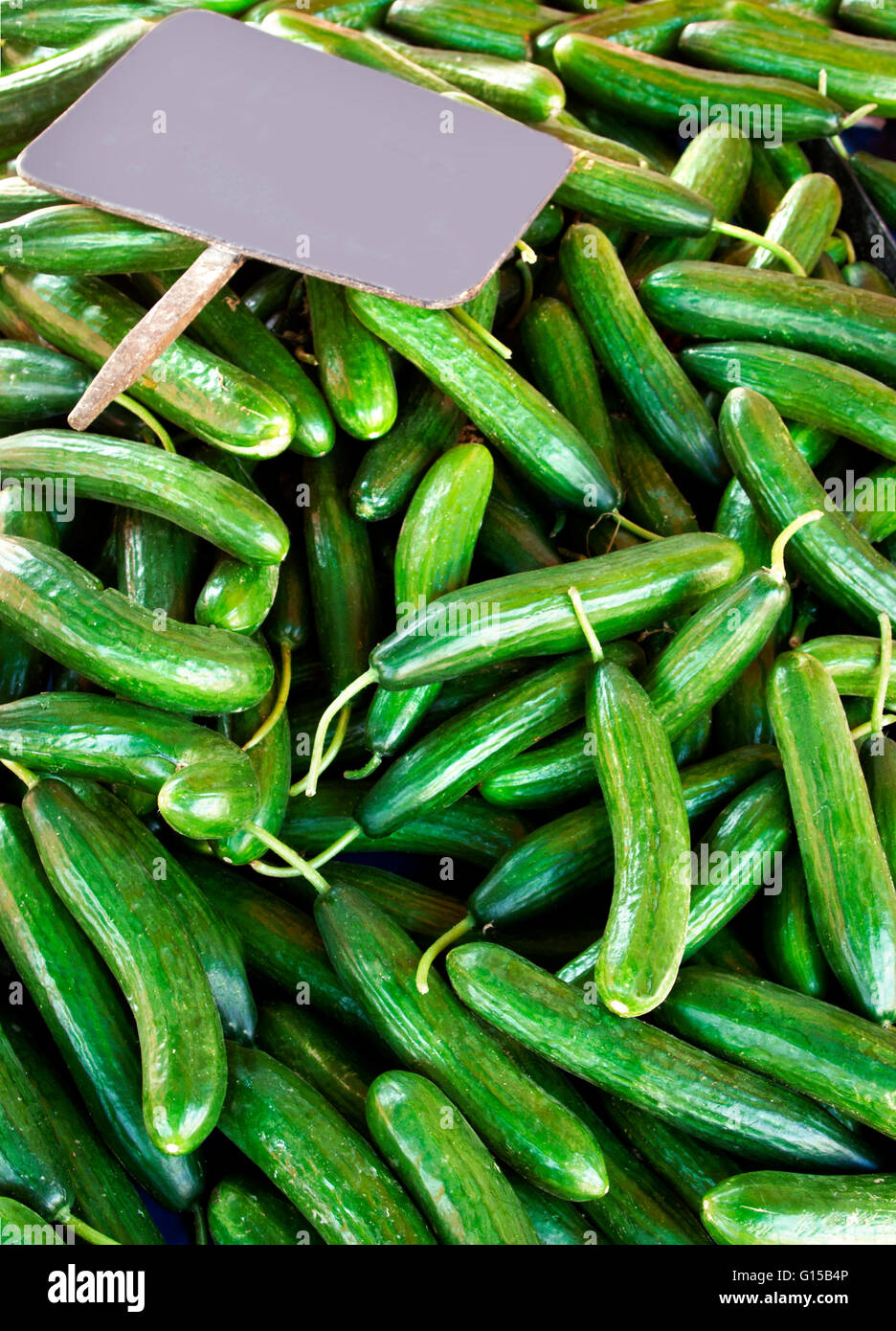 full frame of fresh cucumbers and a handmade blackboard sign for ...