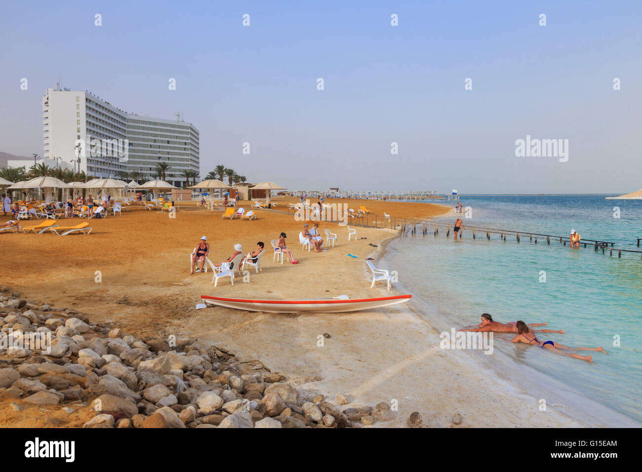 Ein Bokek (En Boqeq) beach, with bathers in the turquoise sea and relaxing ashore, Dead Sea ...