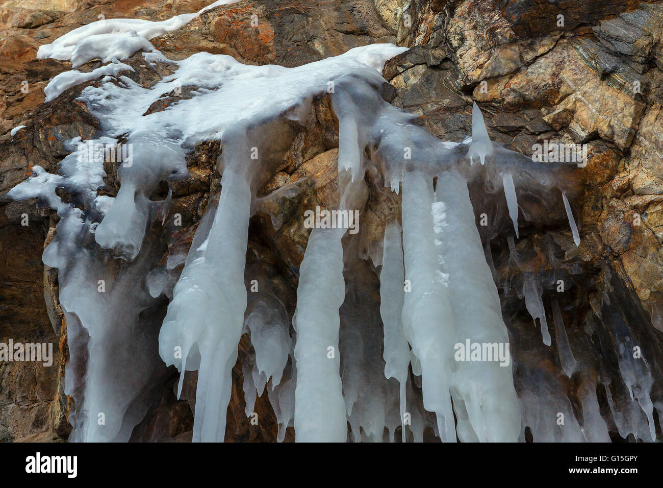 Huge icicles on a cliff Stock Photo - Alamy