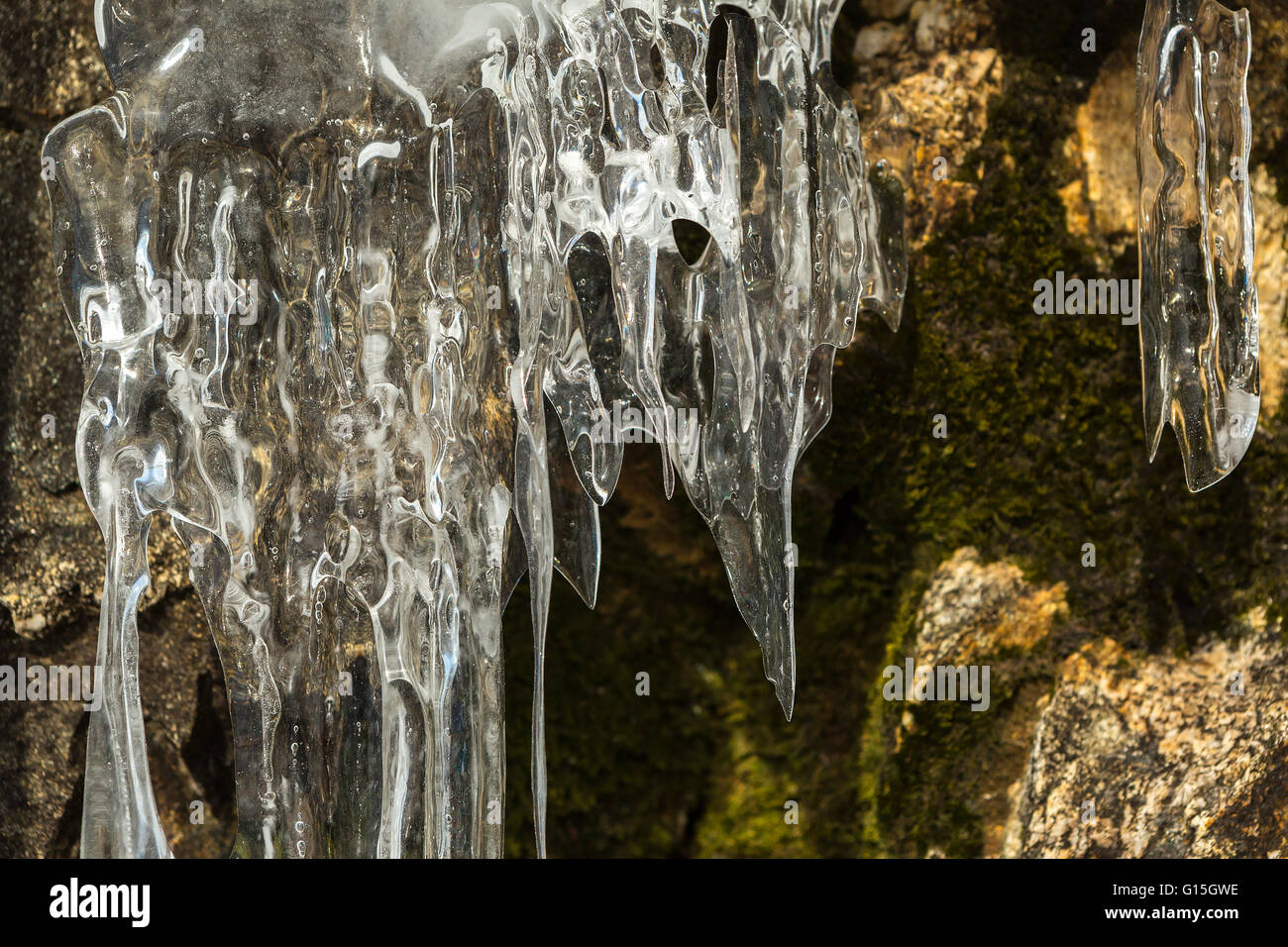 Huge icicles on a cliff Stock Photo - Alamy