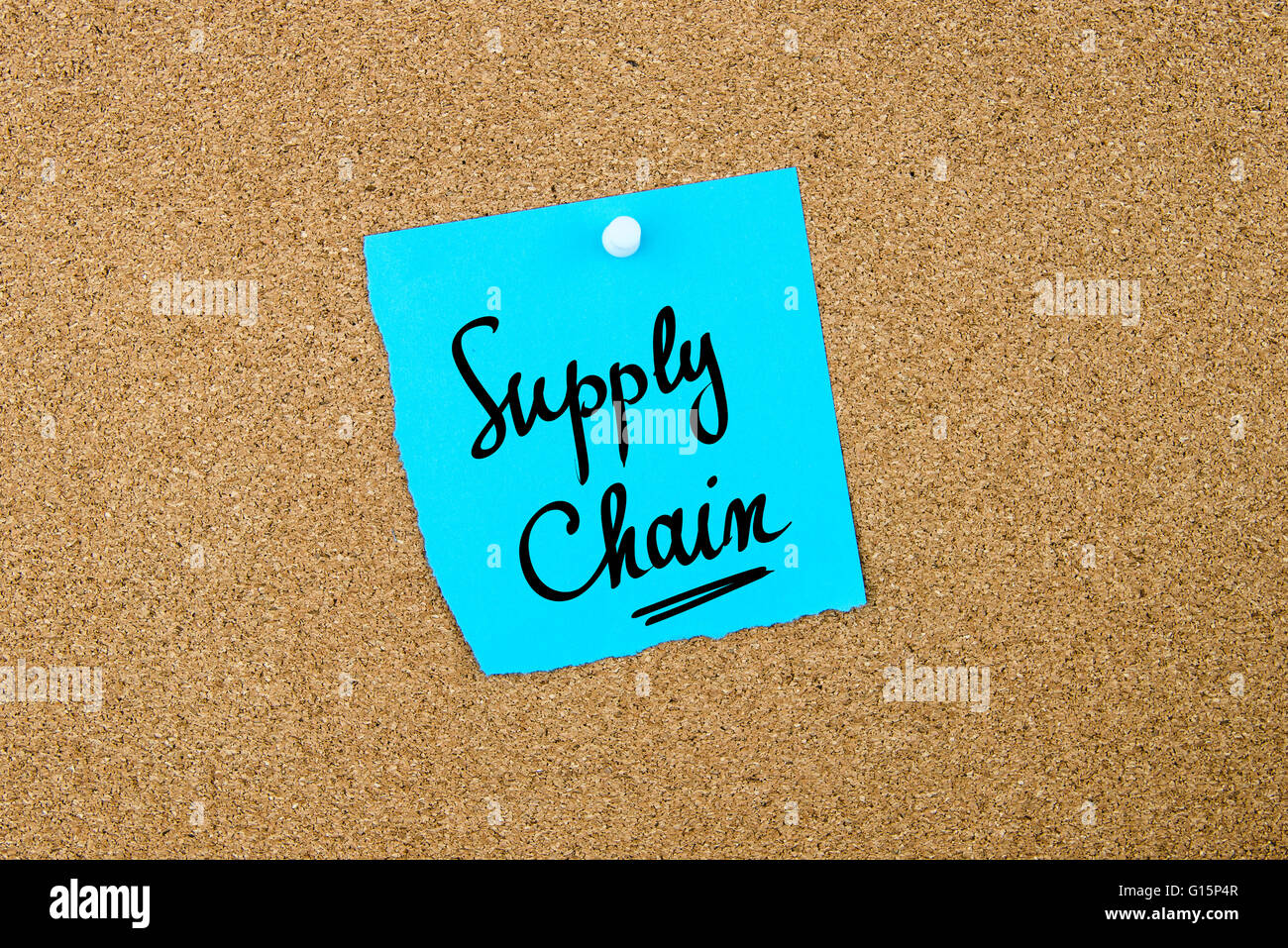 Supply Chain written on blue paper note pinned on cork board with white ...