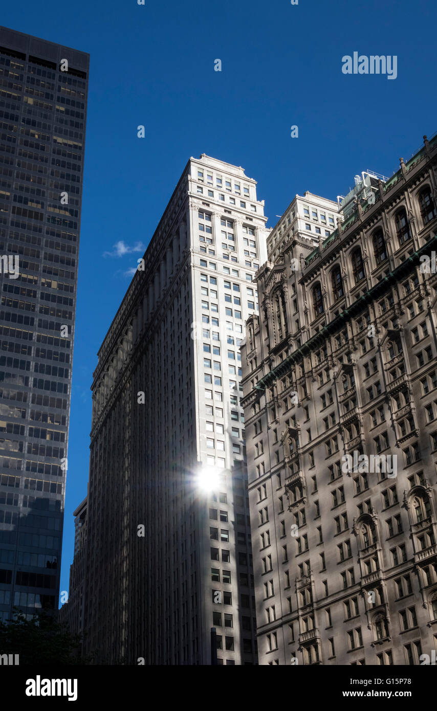 Wall Street Financial District skyscrapers reflect the setting sun in ...