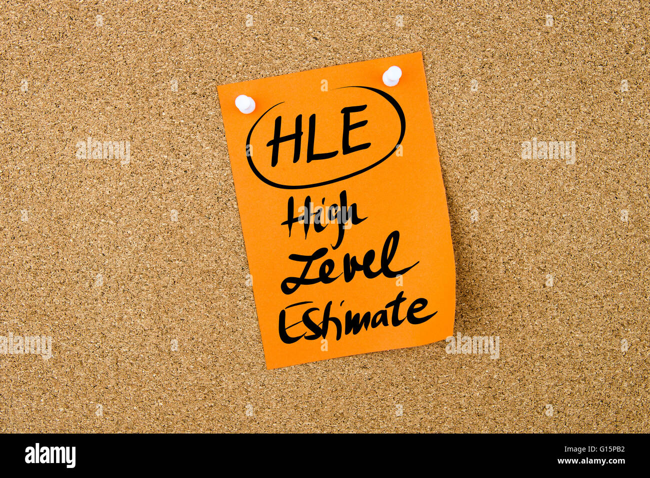 Business Acronym HLE High Level Estimate written on orange paper note ...