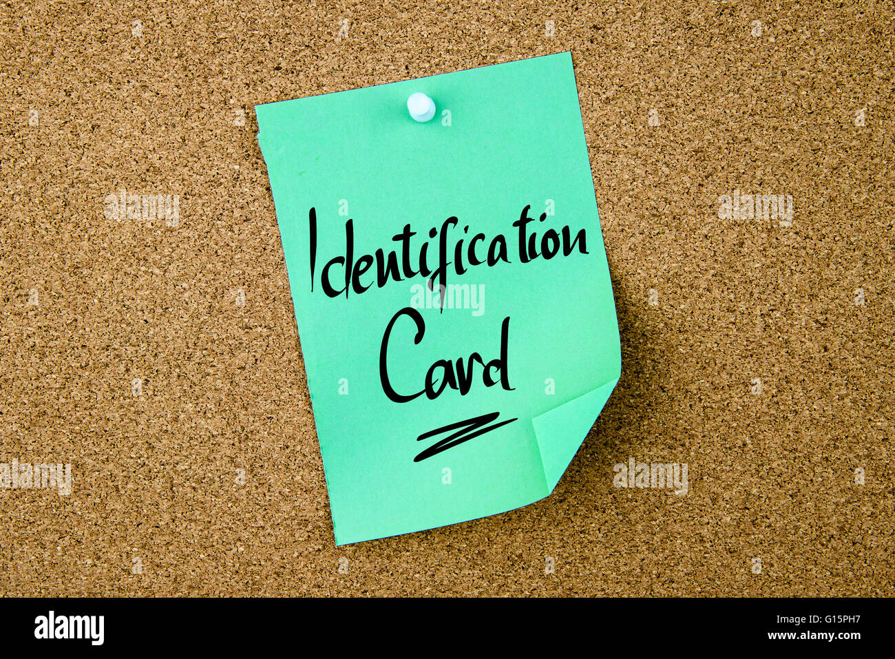 Identification Card written on green paper note pinned on cork board ...