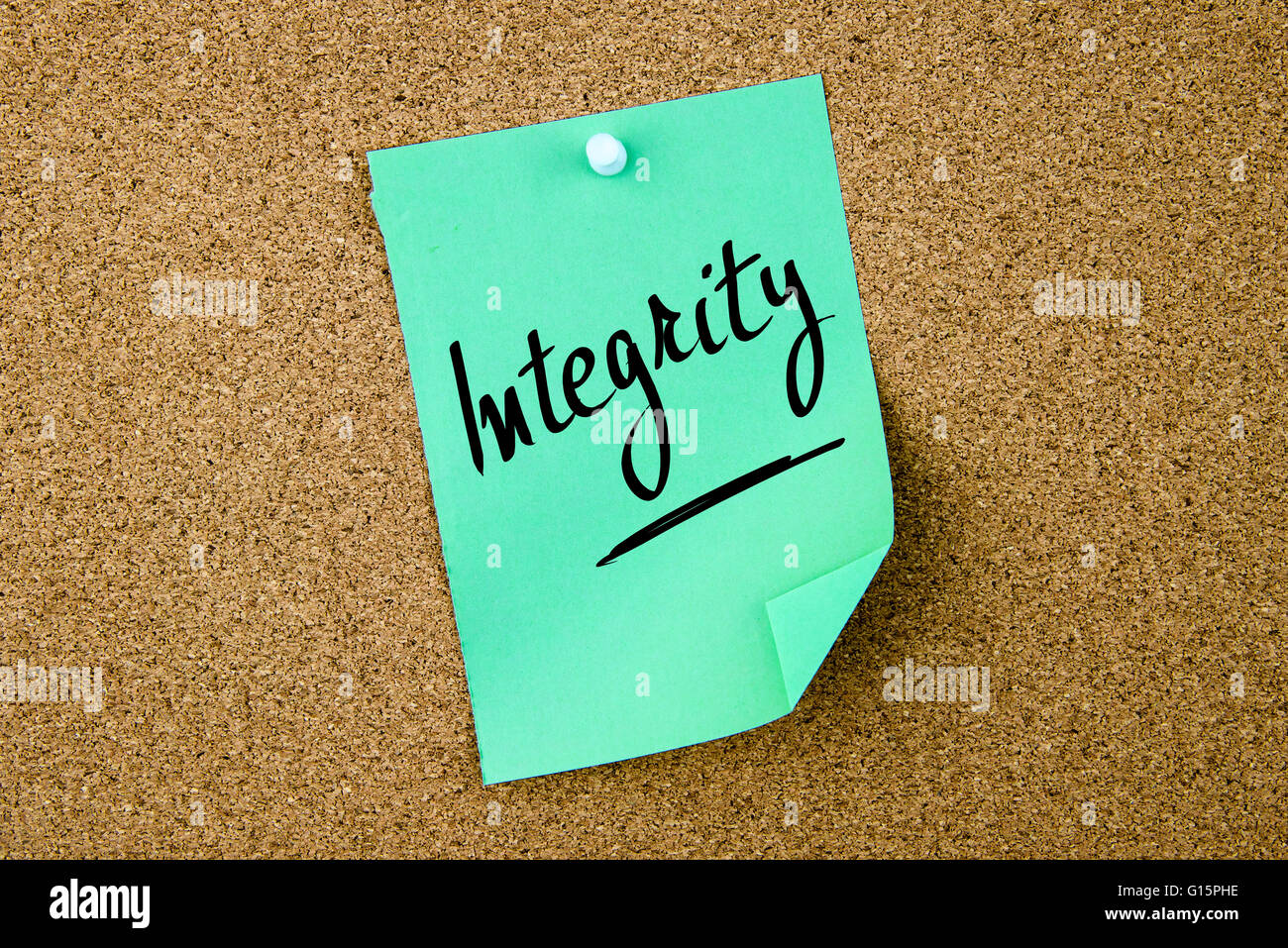 Integrity written on green paper note pinned on cork board with white ...
