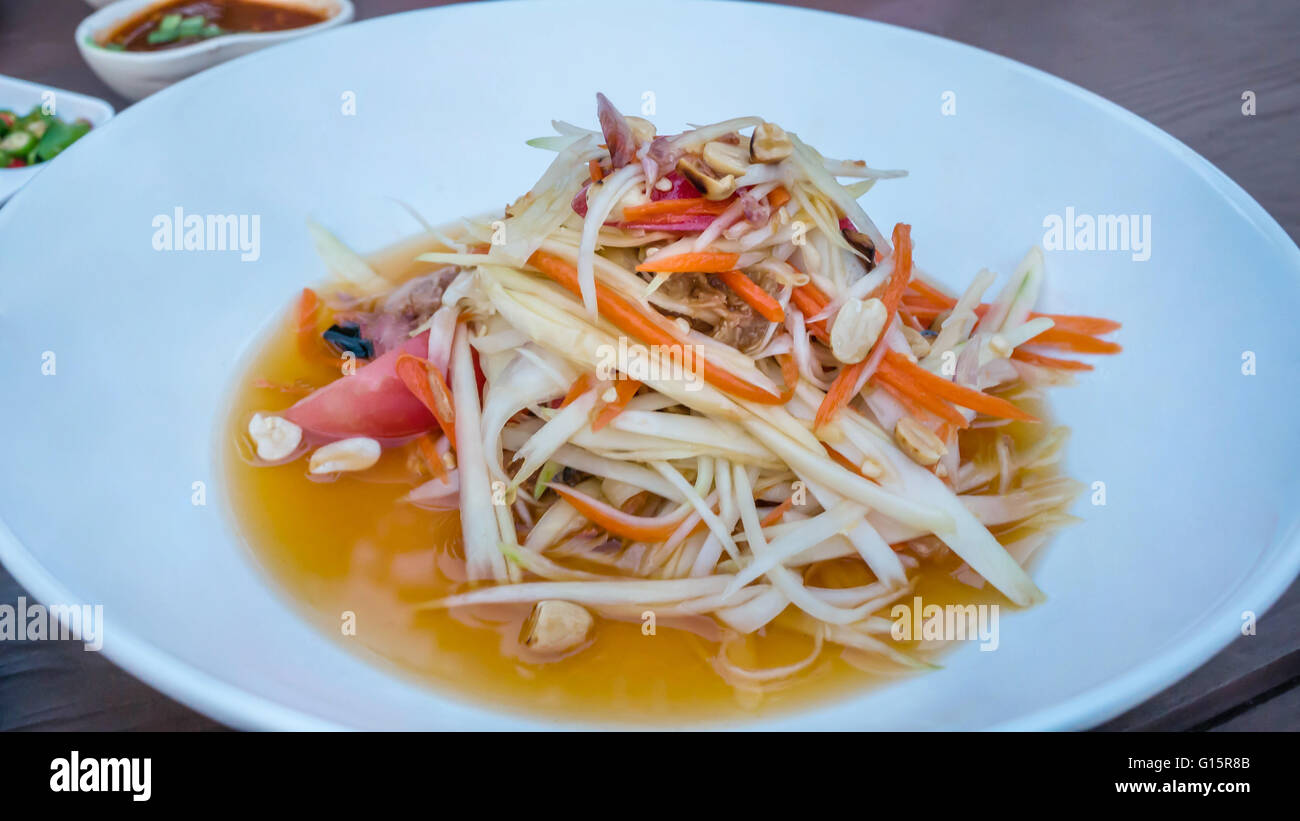 Thai spicy papaya salad on white dish , asian food Stock Photo - Alamy