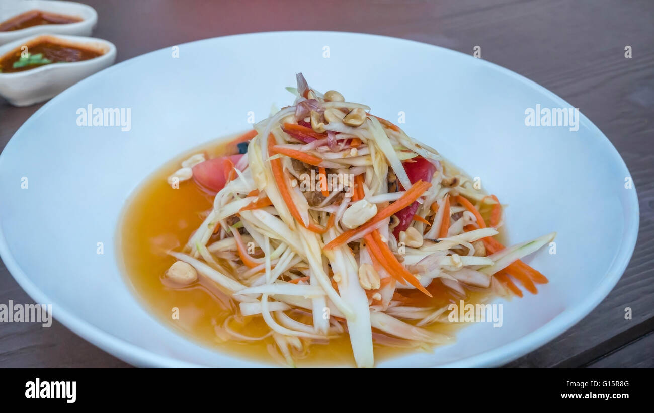 Thai spicy papaya salad on white dish , asian food Stock Photo - Alamy
