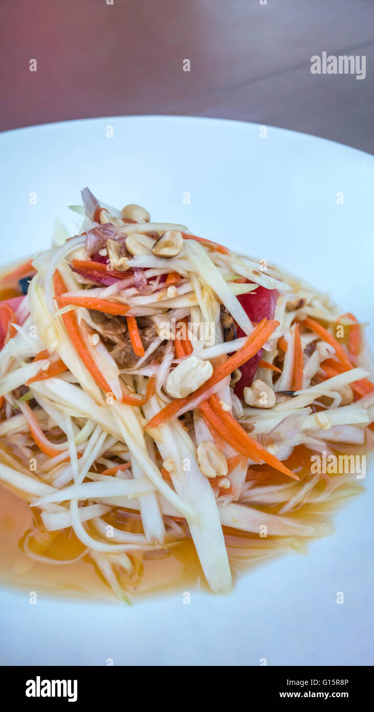 Thai spicy papaya salad on white dish , asian food Stock Photo - Alamy