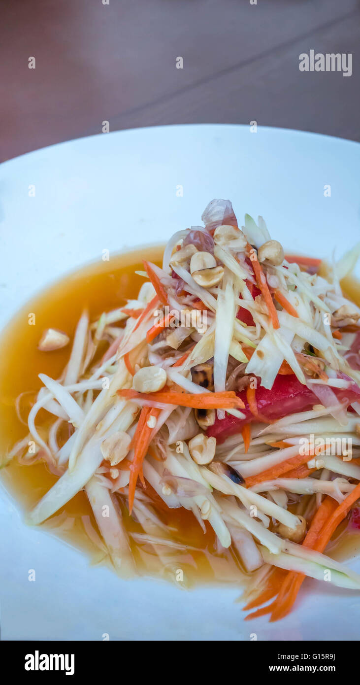 Thai spicy papaya salad on white dish , asian food Stock Photo - Alamy