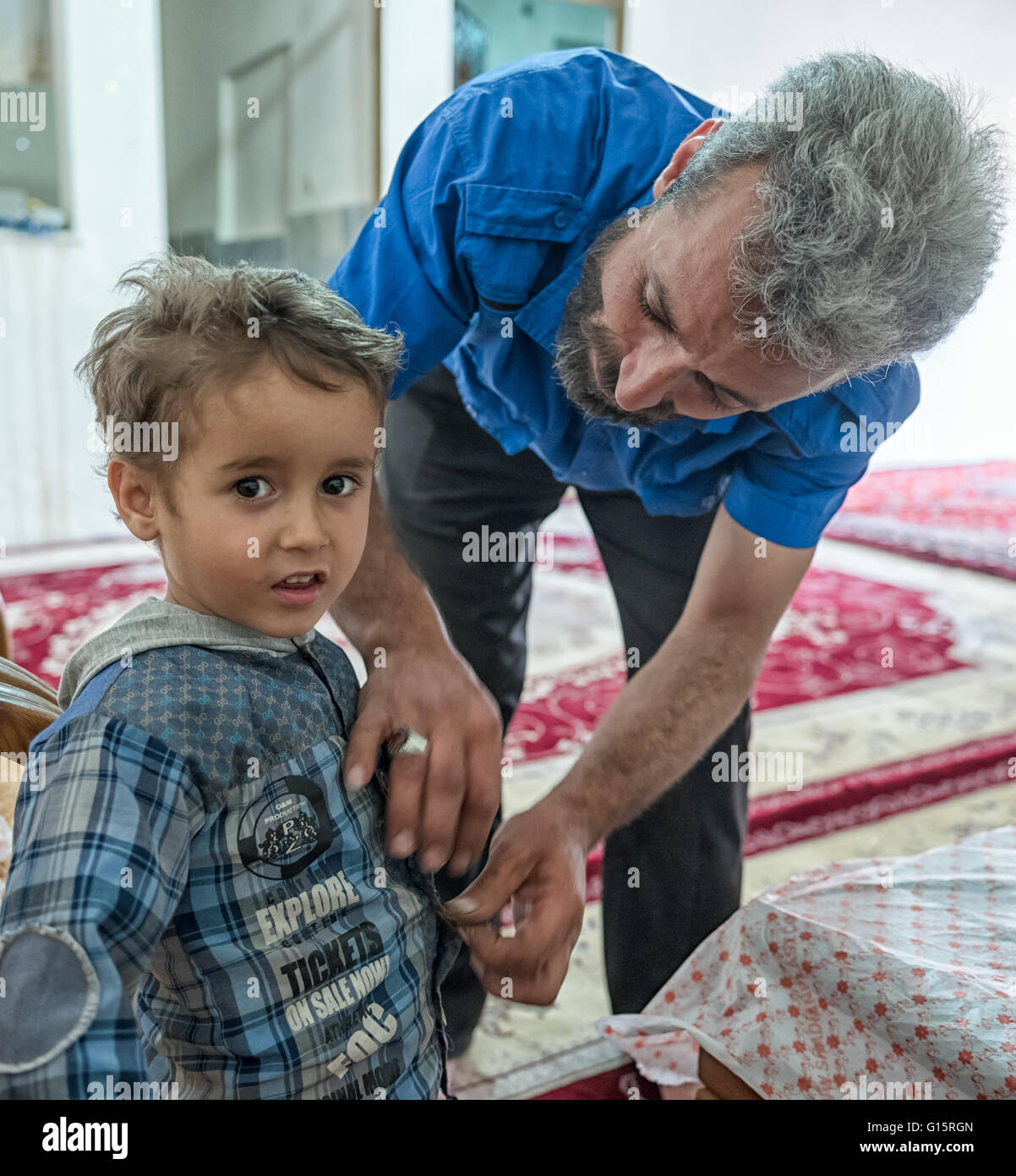 Mohammed Sadat, age 5, with his father Mahdi Sadat in their rural home ...
