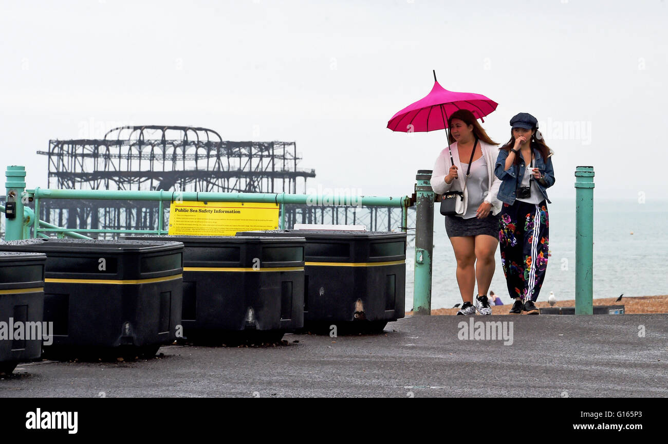 Brighton UK 10th May 2016 - Walkers out with umbrellas on Brighton ...