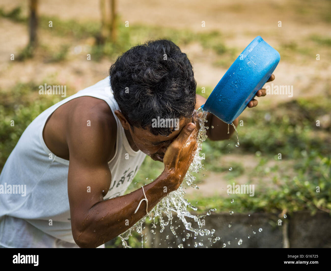 Ta Tum, Surin, Thailand. 10th May, 2016. A man washes his face at the ...