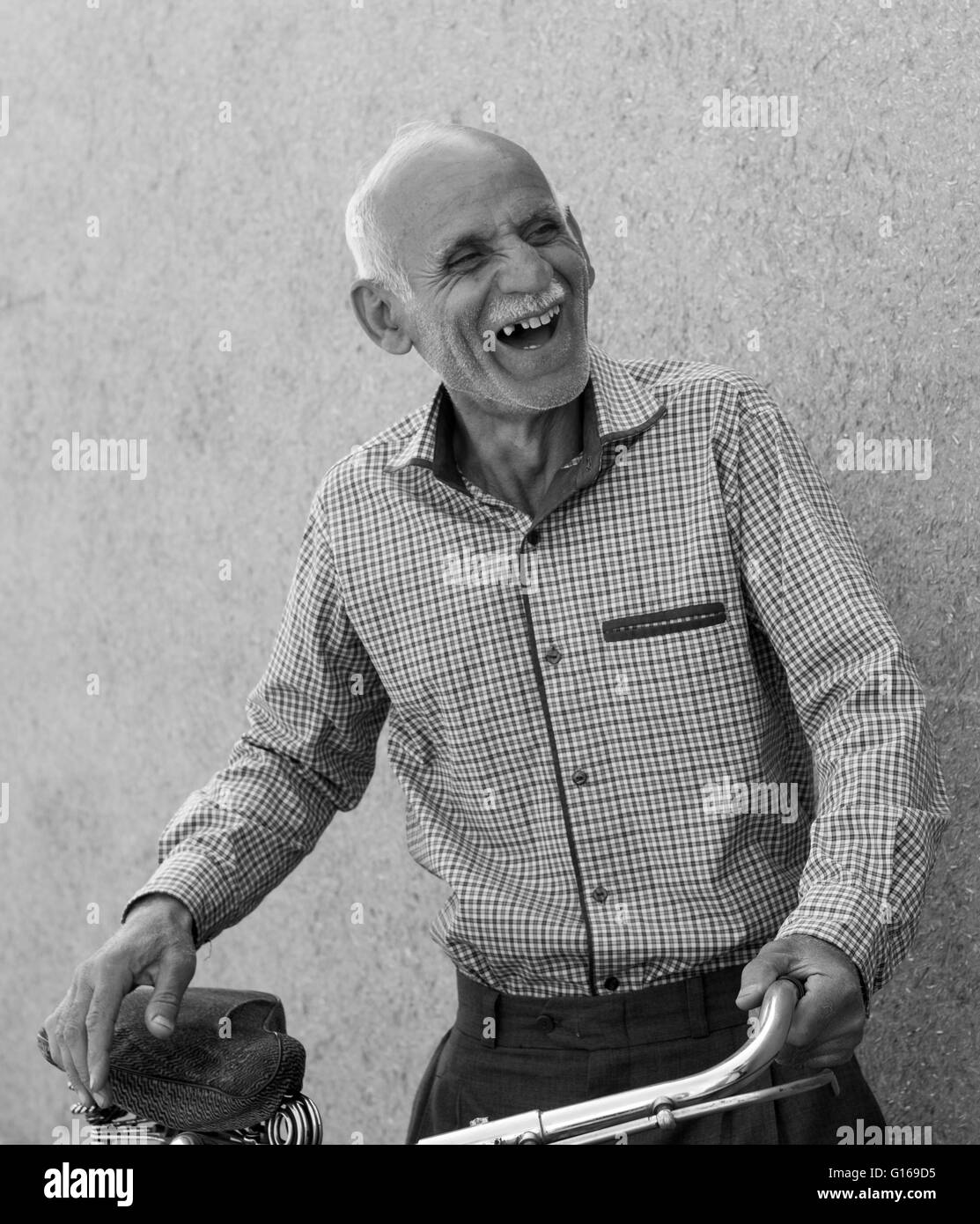 Iranian man on the street in Kashan, Iran, telling jokes and laughing ...