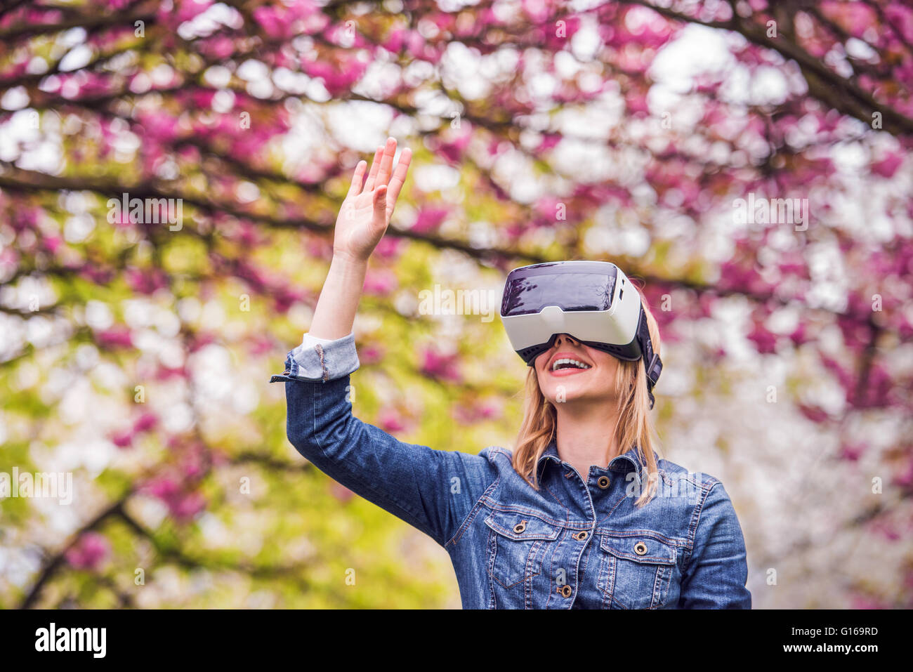 Woman wearing virtual reality goggles outside in spring nature Stock ...