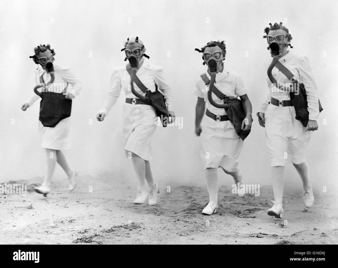 Nurses advancing through a cloud of smoke in a gas mask drill of the U ...