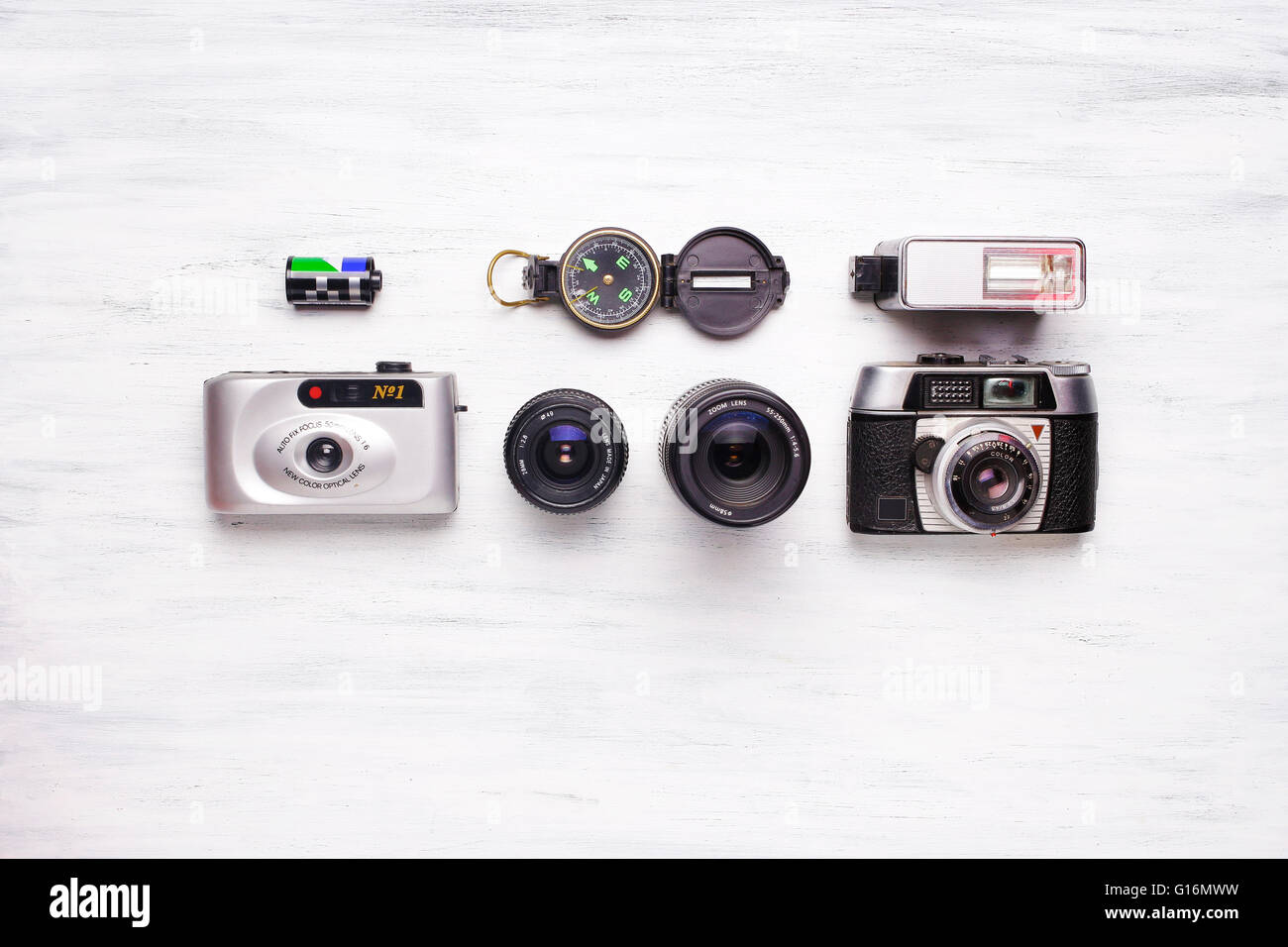 Top view of collection of vintage cameras on a white wooden table, with ...