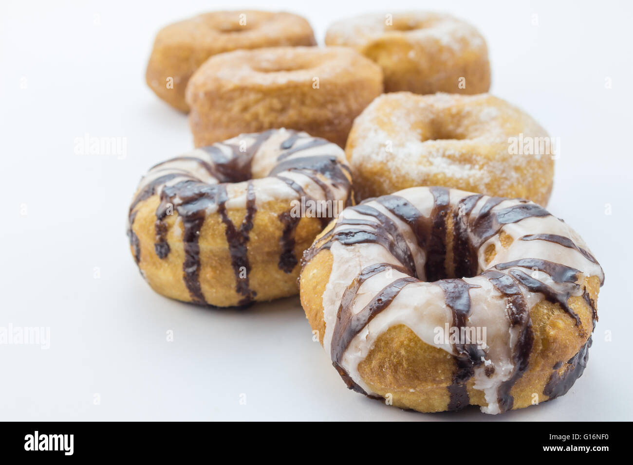 Various doughnuts close up isolated on white background Stock Photo - Alamy