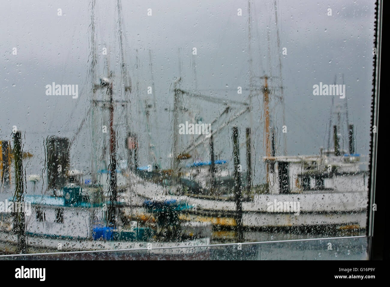 Fishing boats in Pelican Harbor, AK seen through rain-splattered window ...