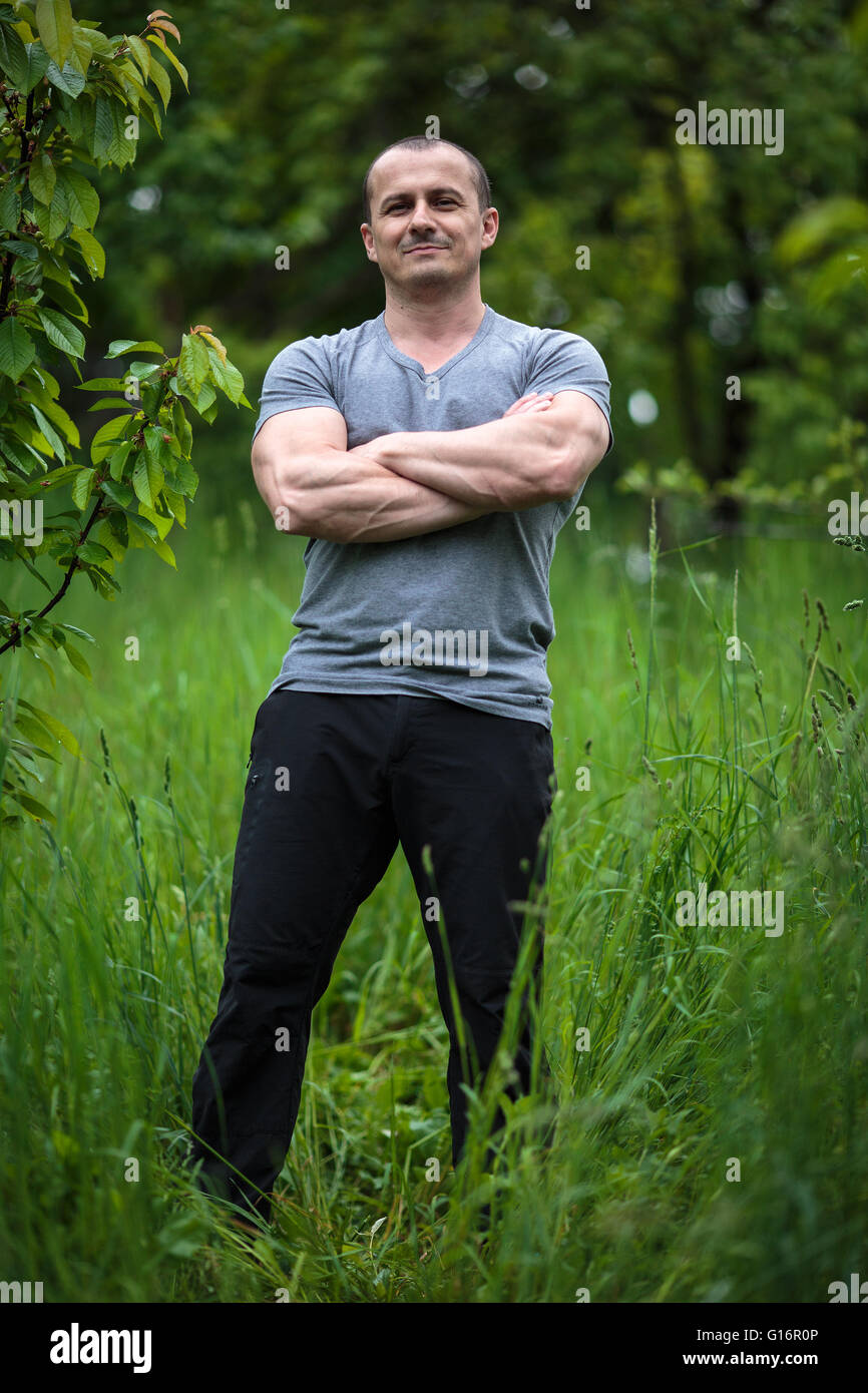 European farmer in the high grass in his orchard Stock Photo - Alamy