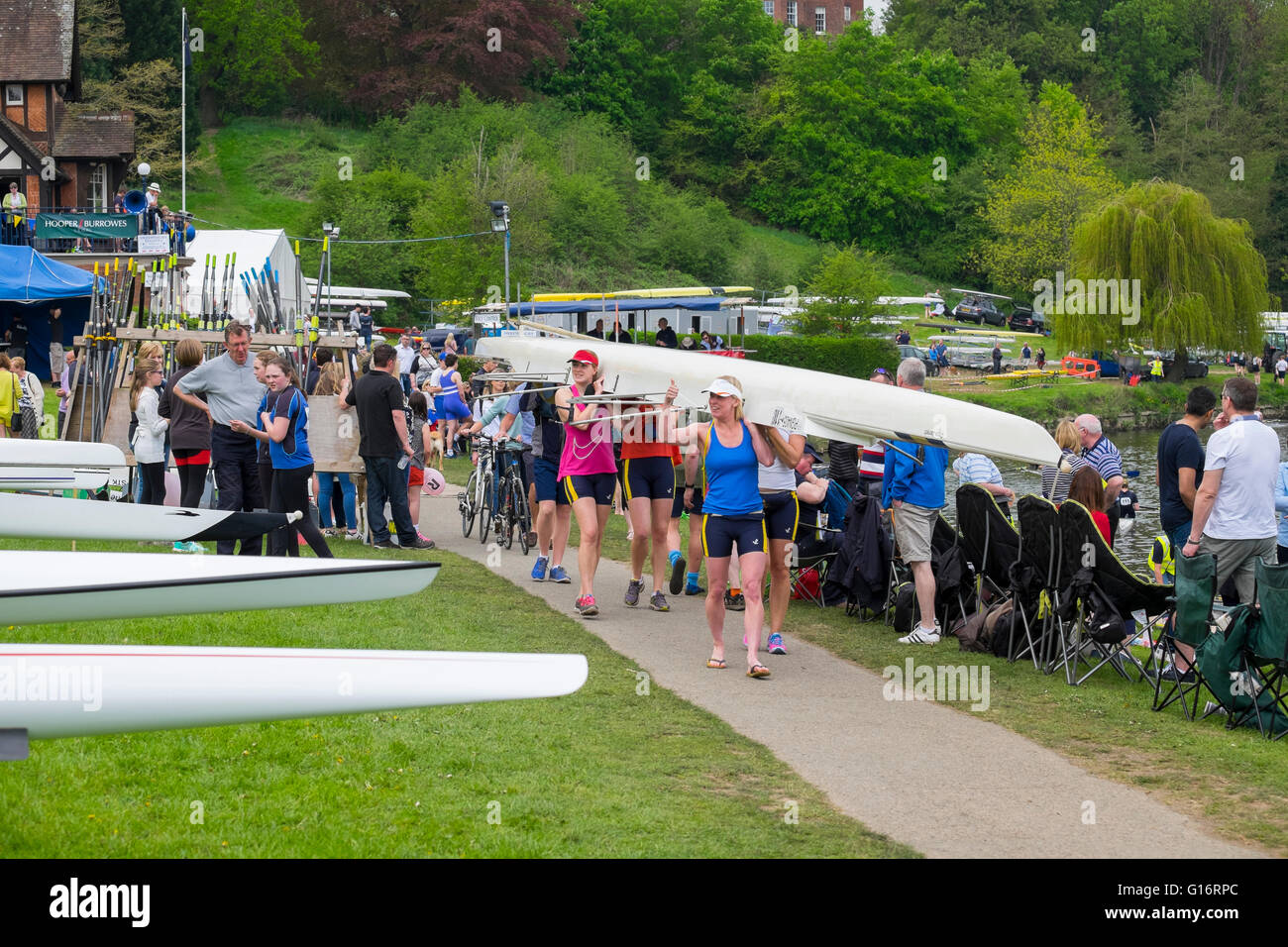 A female rowing crew carrying a boat at Shrewsbury Regatta beside the ...