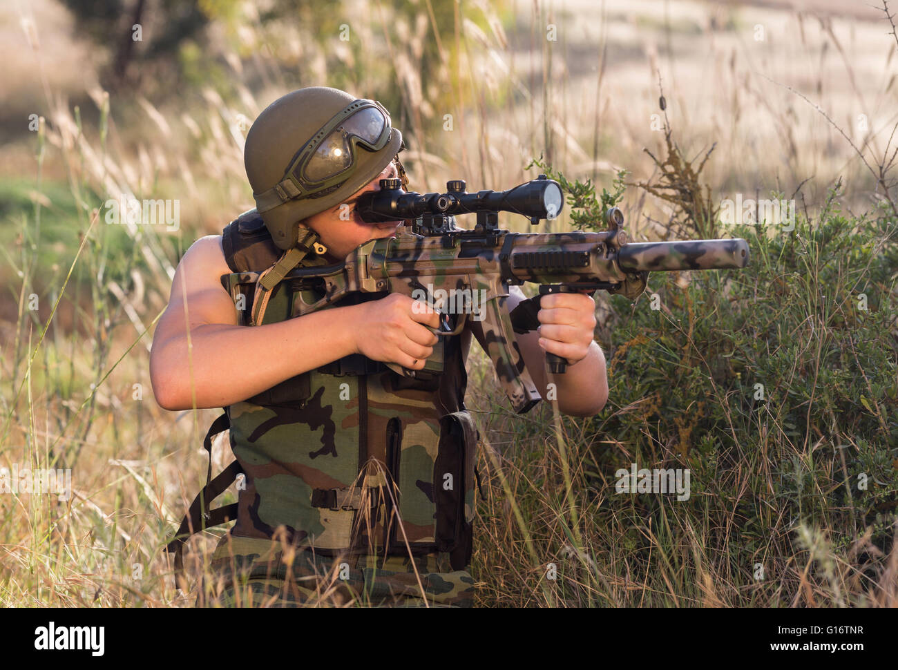young a soldier in the uniform with weapon Stock Photo - Alamy