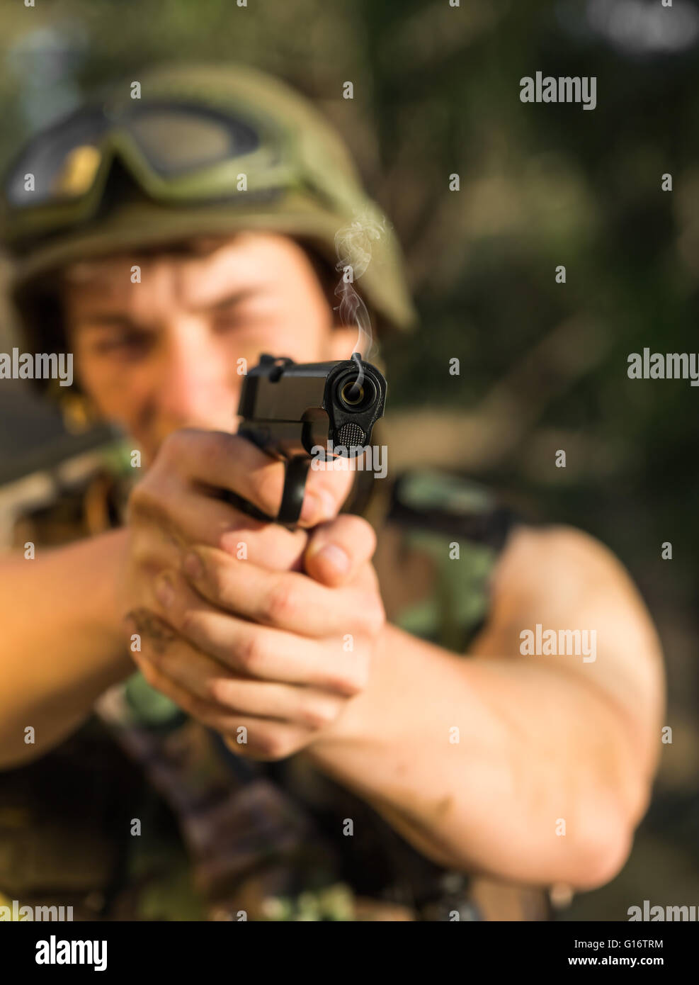 young a soldier in the uniform with weapon Stock Photo - Alamy