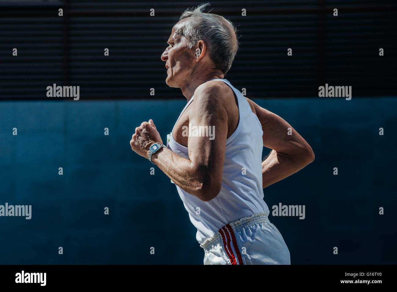 elderly man athlete running on a city street during City marathon Stock ...