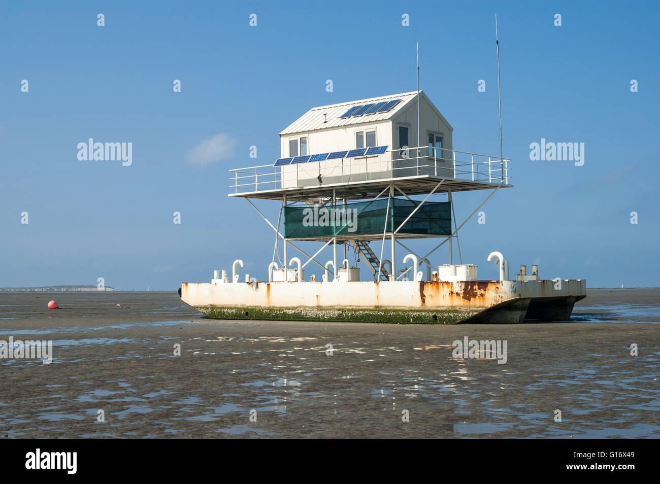 Birdwatch cabin on the tidal flats at low tide of the wetlands, Wadden ...