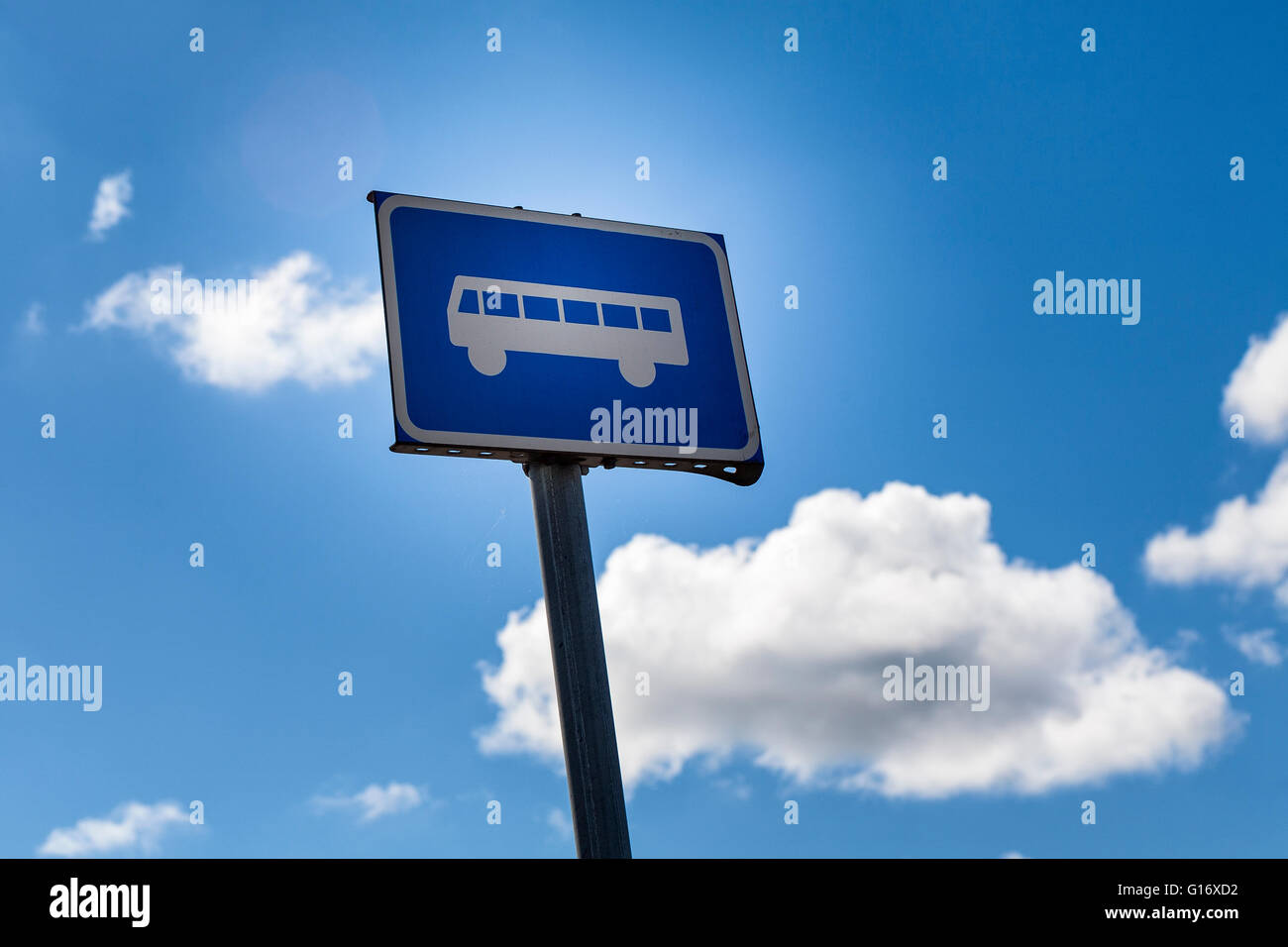 Bus sign post against blue sky with fluffy clouds Model Release: No ...
