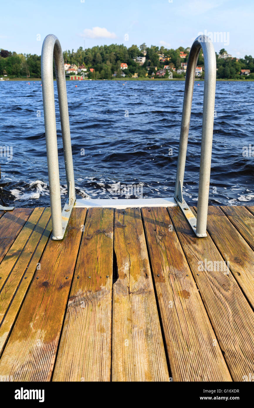 Empty jetty and jetty ladder at lake Rådasjön, Västra Götaland, Sweden ...