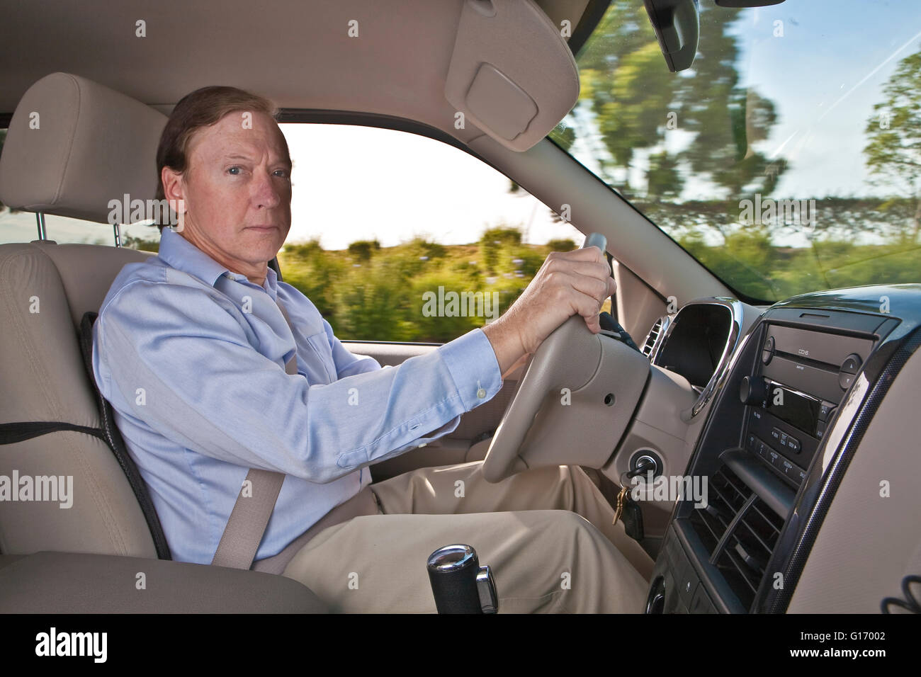 Passenger seat view of older man driving SUV Stock Photo - Alamy
